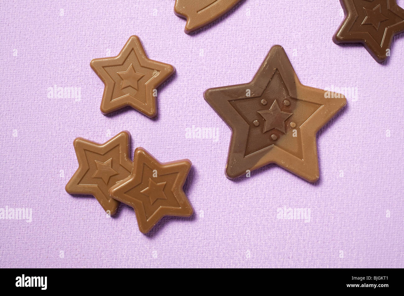 Chocolate stars on purple background Stock Photo - Alamy