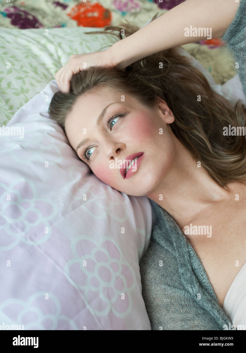 Beautiful woman lying on bed hi-res stock photography and images - Alamy