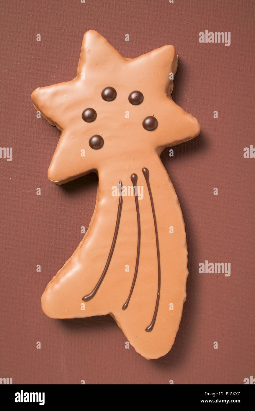 Shooting star biscuit with chocolate icing on brown background Stock ...