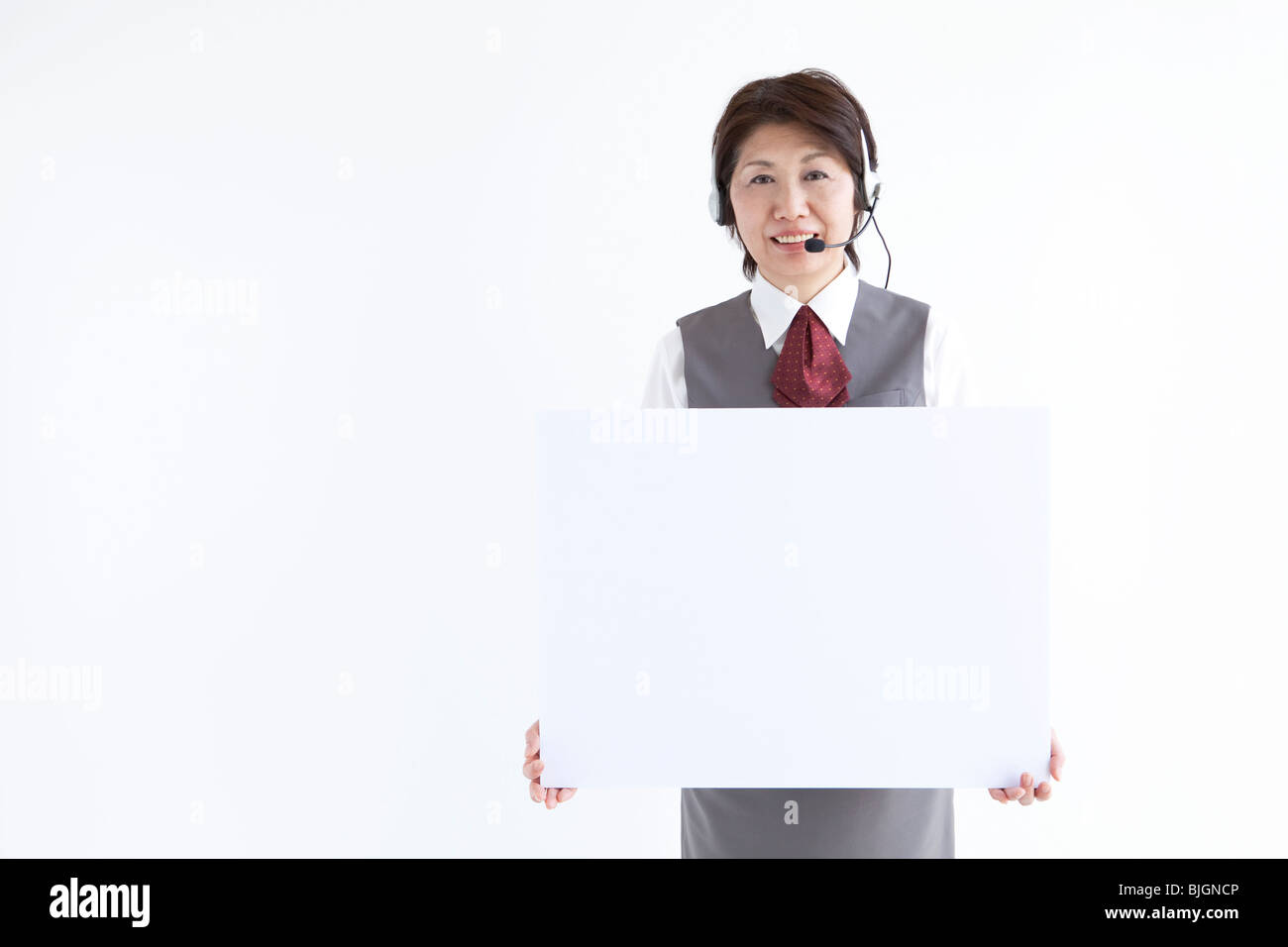 Businesswoman holding up blank sign Stock Photo - Alamy