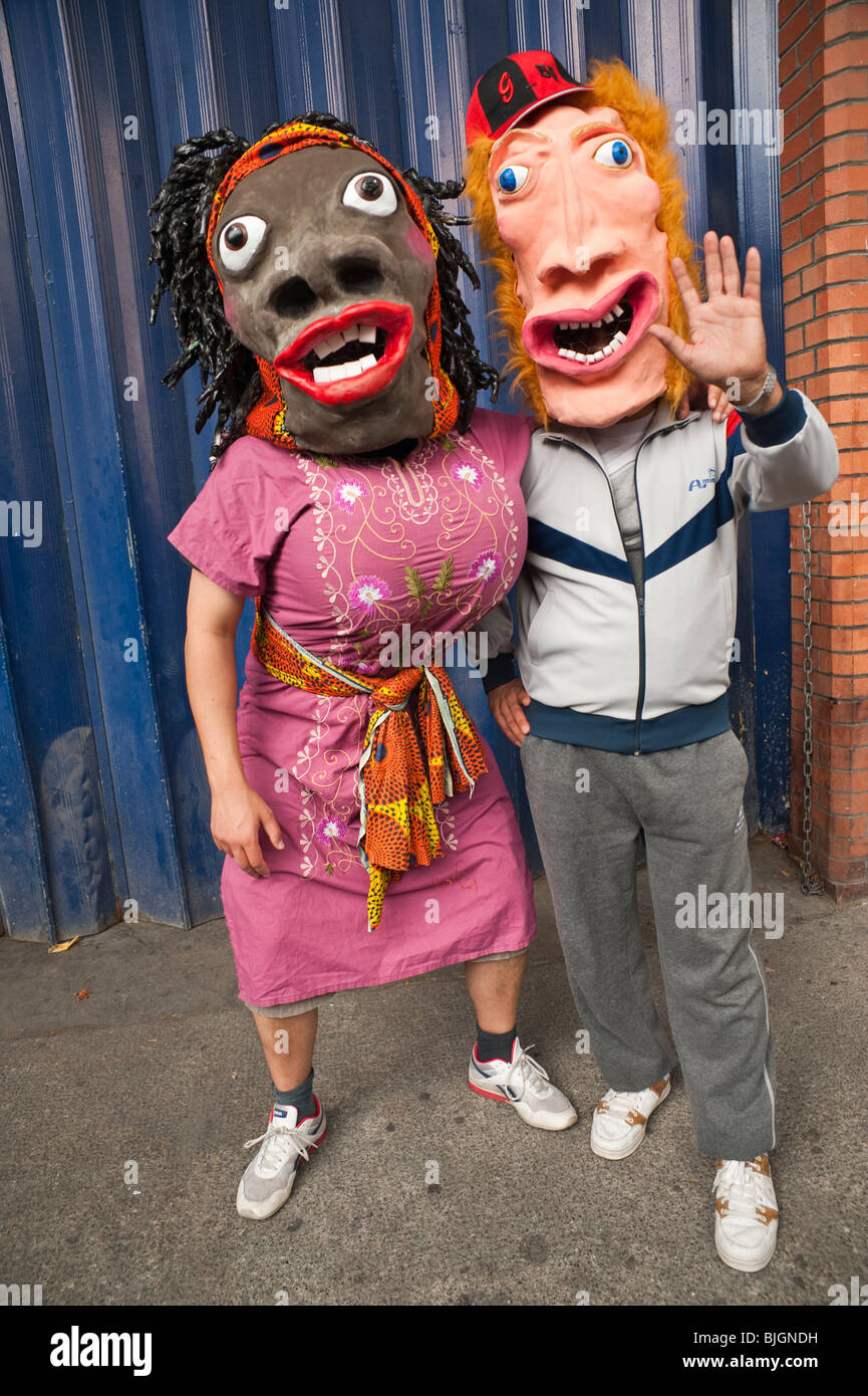 Two people with giant puppet heads at Carnaval del Pueblo procession ...