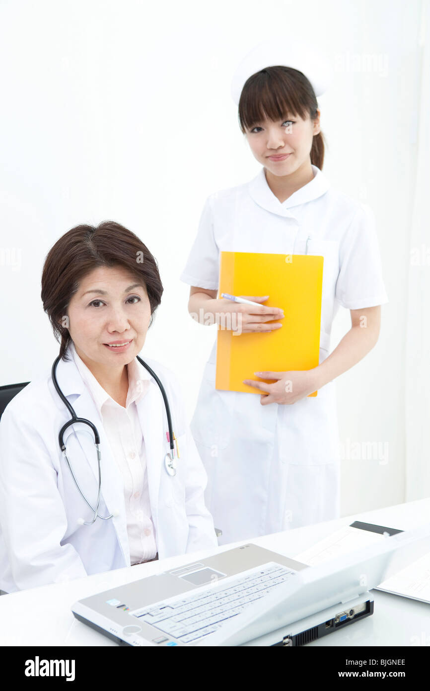 Doctor and nurse with file Stock Photo - Alamy