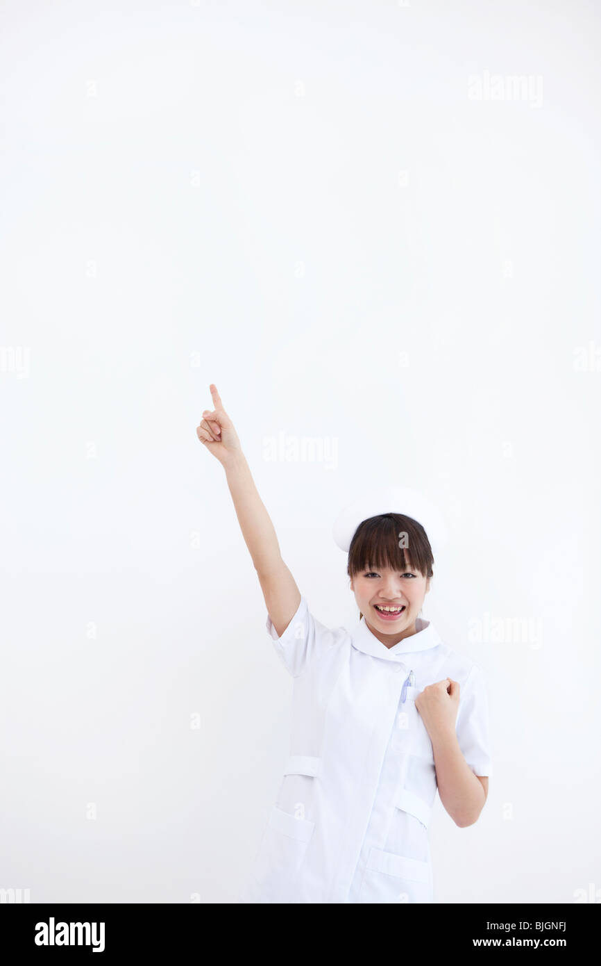 Cheerful nurse pointing finger Stock Photo - Alamy