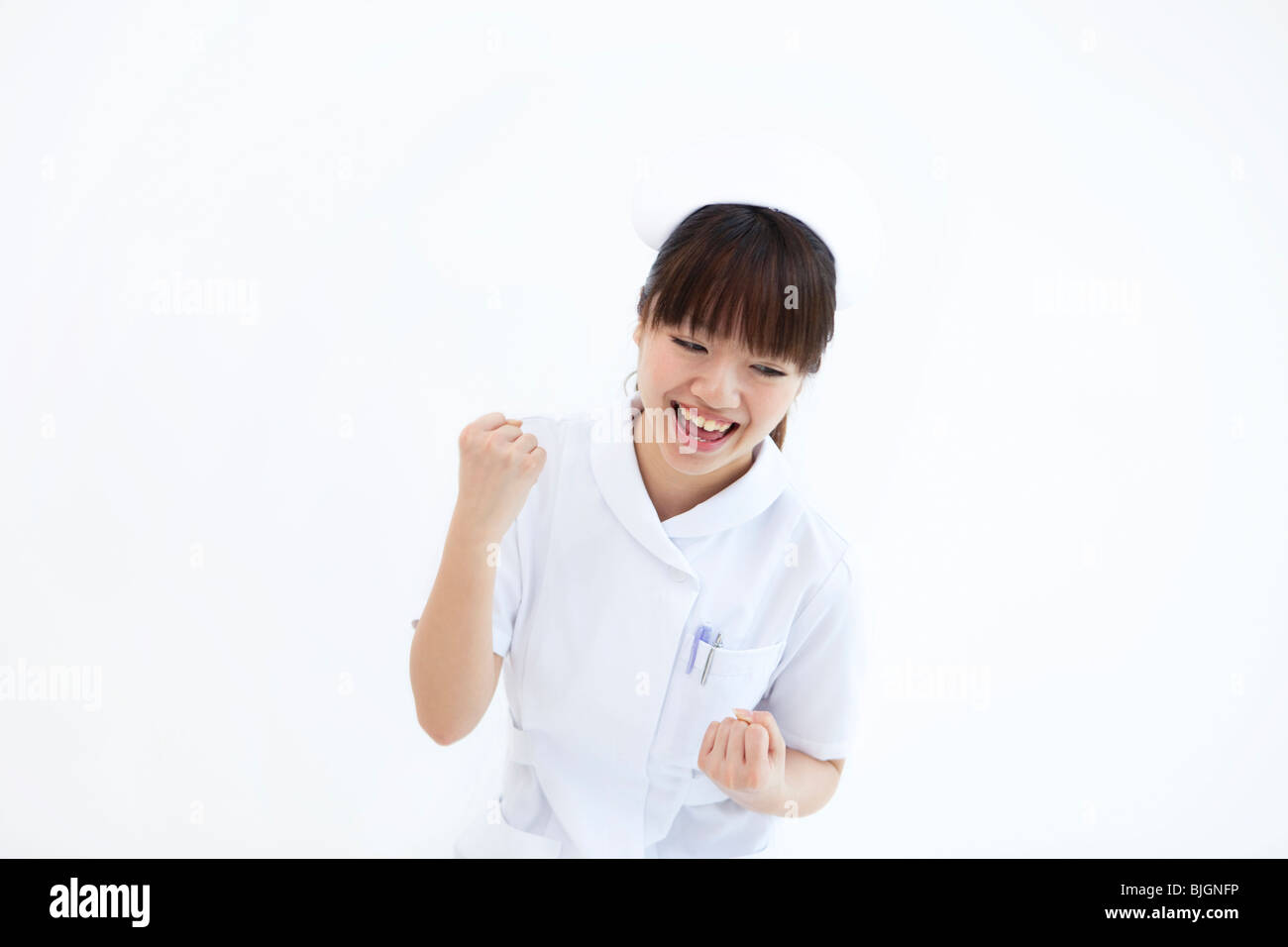 Nurse doing victory pose Stock Photo - Alamy
