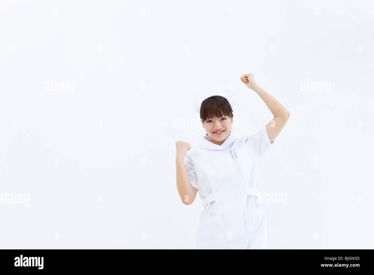 Nurse doing victory pose Stock Photo - Alamy