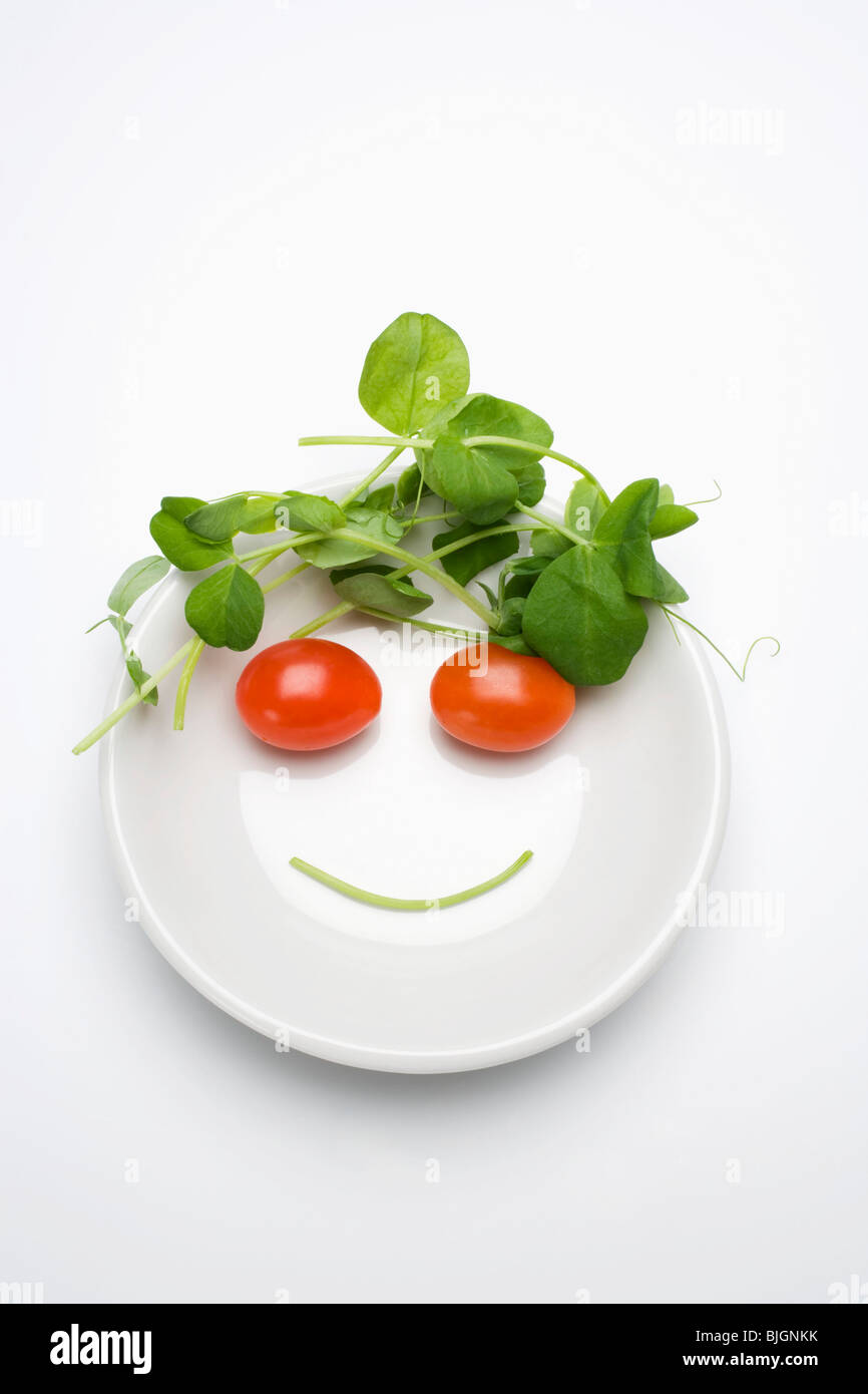 Vegetable face in a soup plate Stock Photo - Alamy