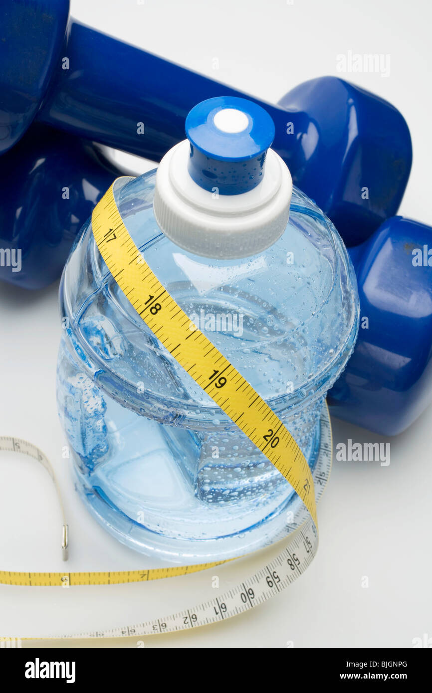 Bottle of water, hand weights and tape measure Stock Photo - Alamy