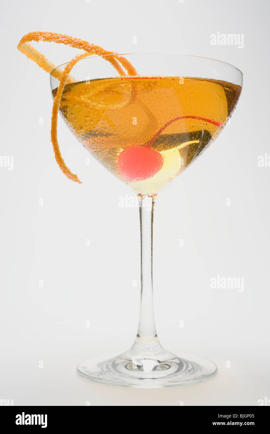 Manhattan with cocktail cherry and orange zest Stock Photo - Alamy