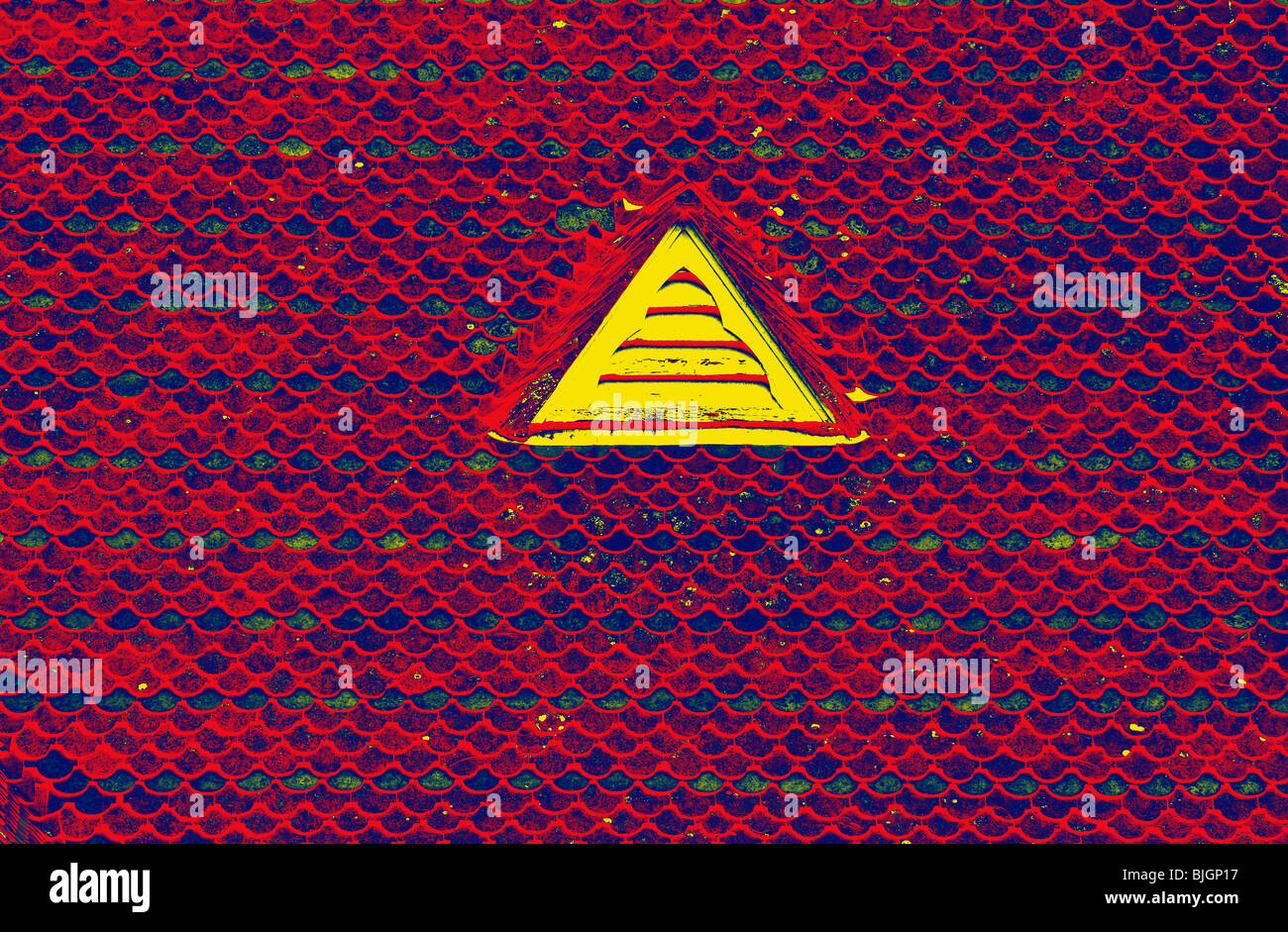 Yellow triangle on red Stock Photo - Alamy