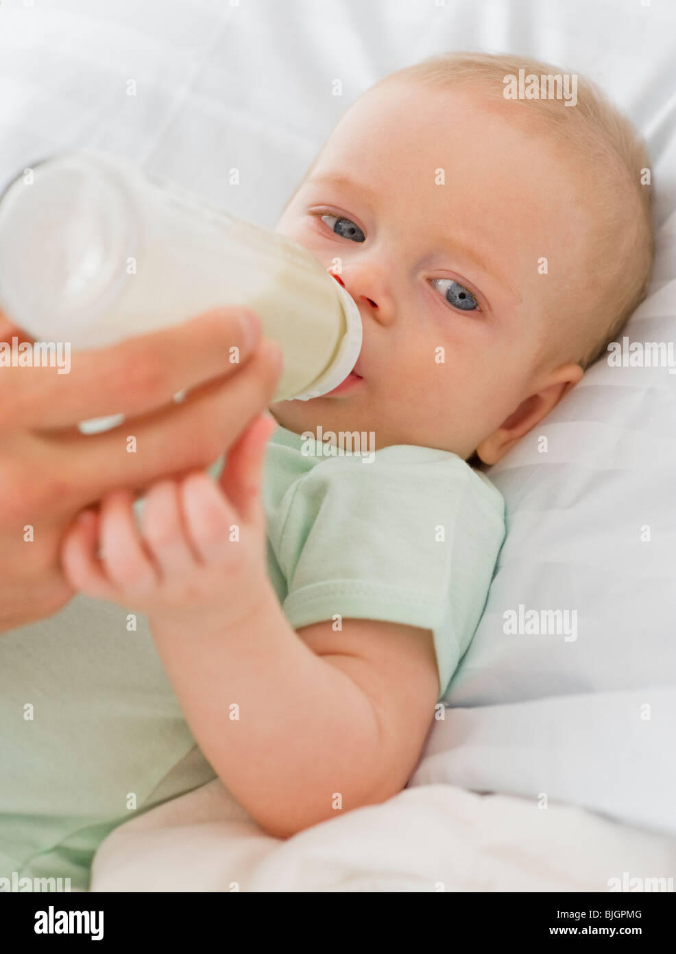 Baby drinking from bottle Stock Photo - Alamy