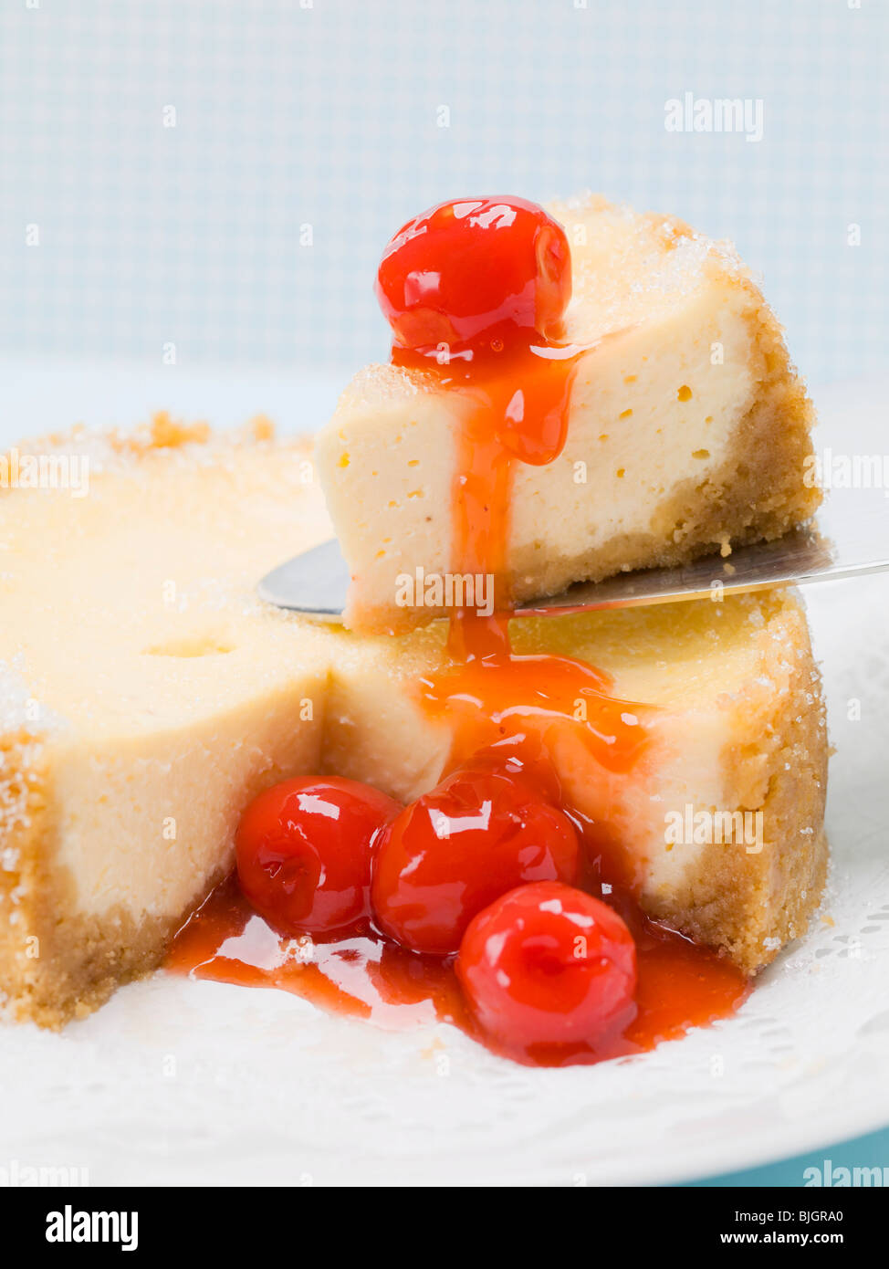 Small cheesecake with cocktail cherries, one piece on server Stock ...
