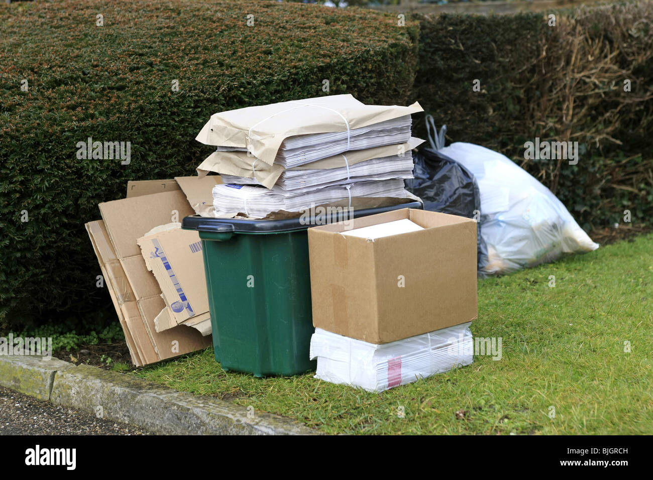 Cardboard and paper waste ready for recycling collection by the loacl ...