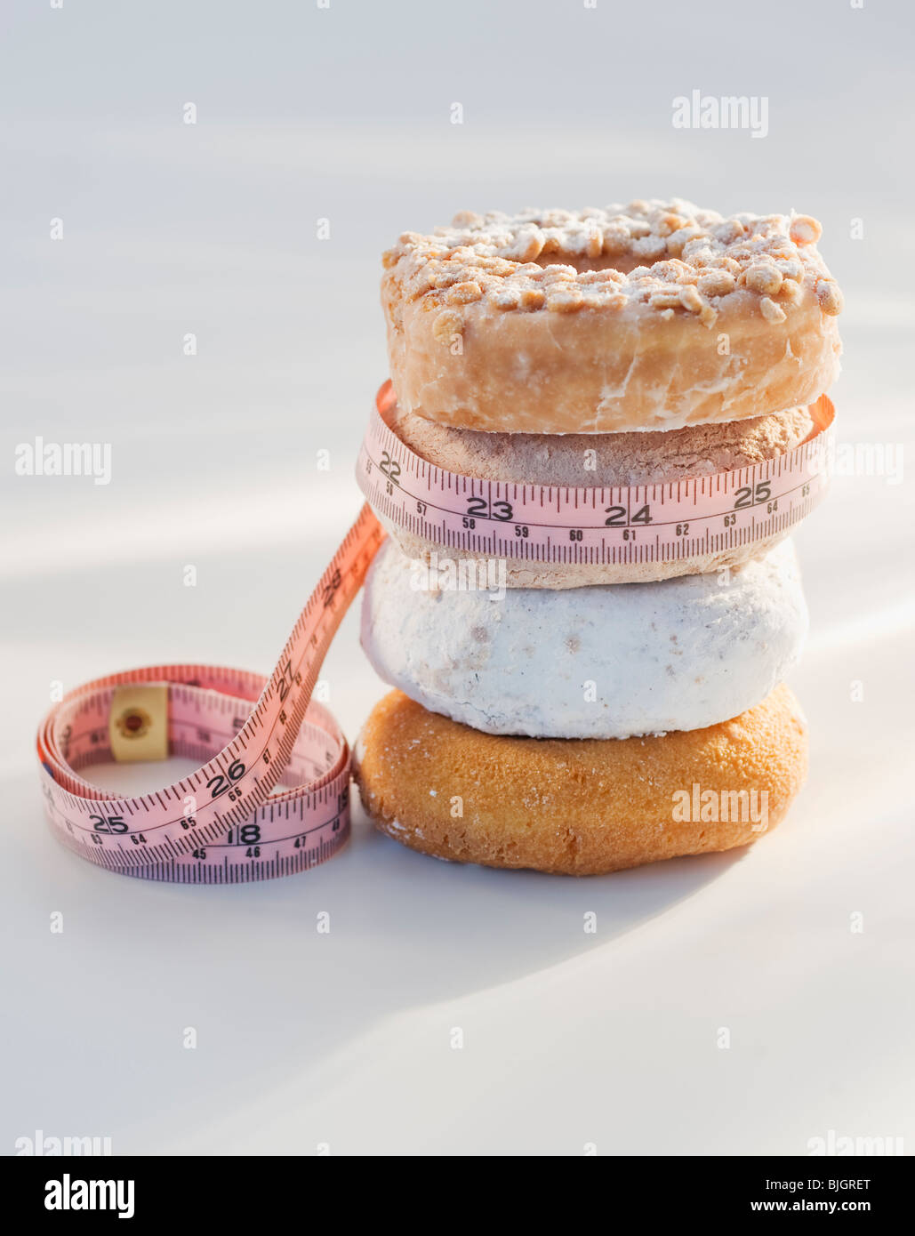 Donuts and measuring tape Stock Photo - Alamy