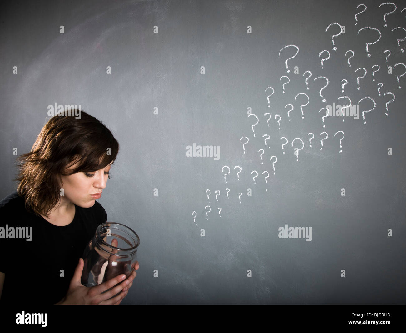 woman with a jar full of question marks Stock Photo - Alamy