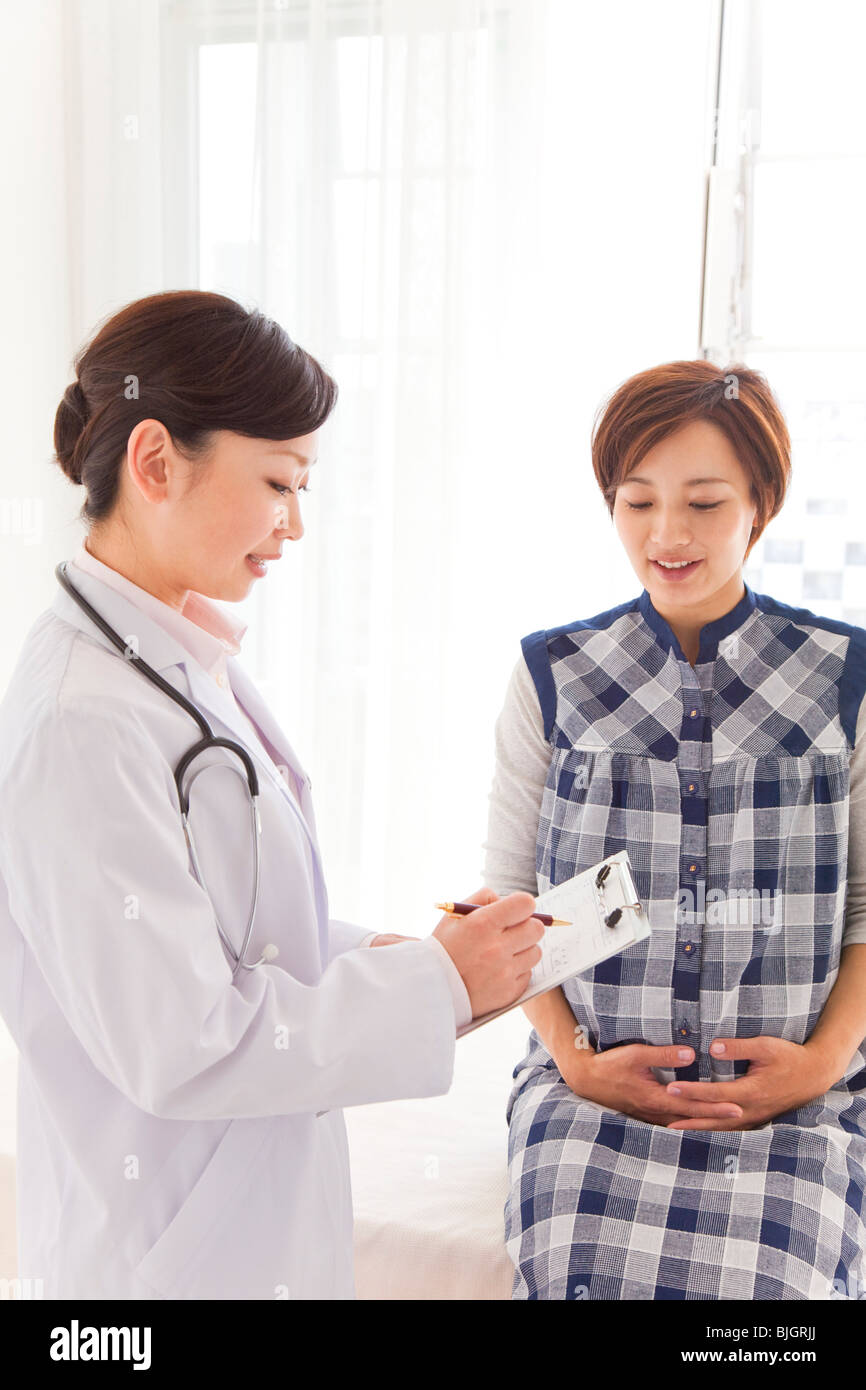 Pregnant woman having check up with gynecologist Stock Photo - Alamy