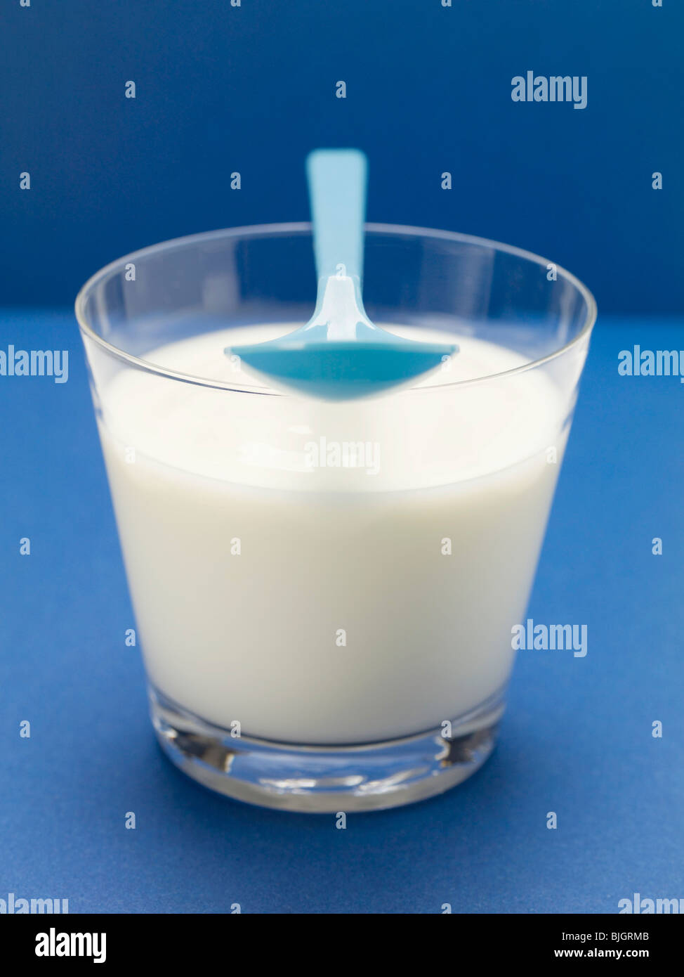 Yoghurt in glass with plastic spoon Stock Photo - Alamy