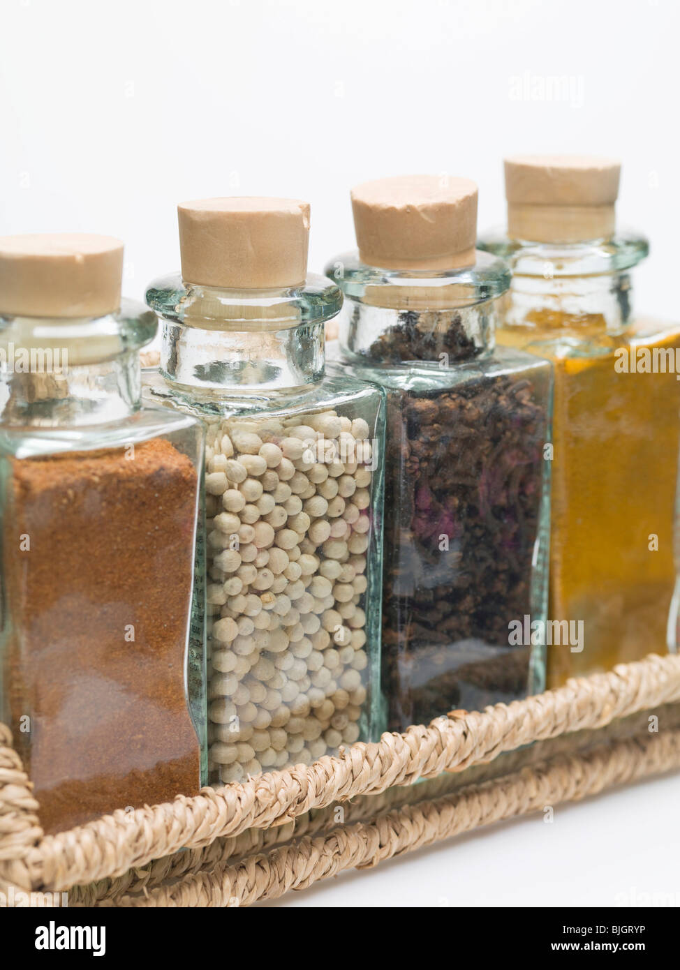 Nutmeg, white peppercorns, cloves & turmeric in spice rack Stock Photo ...