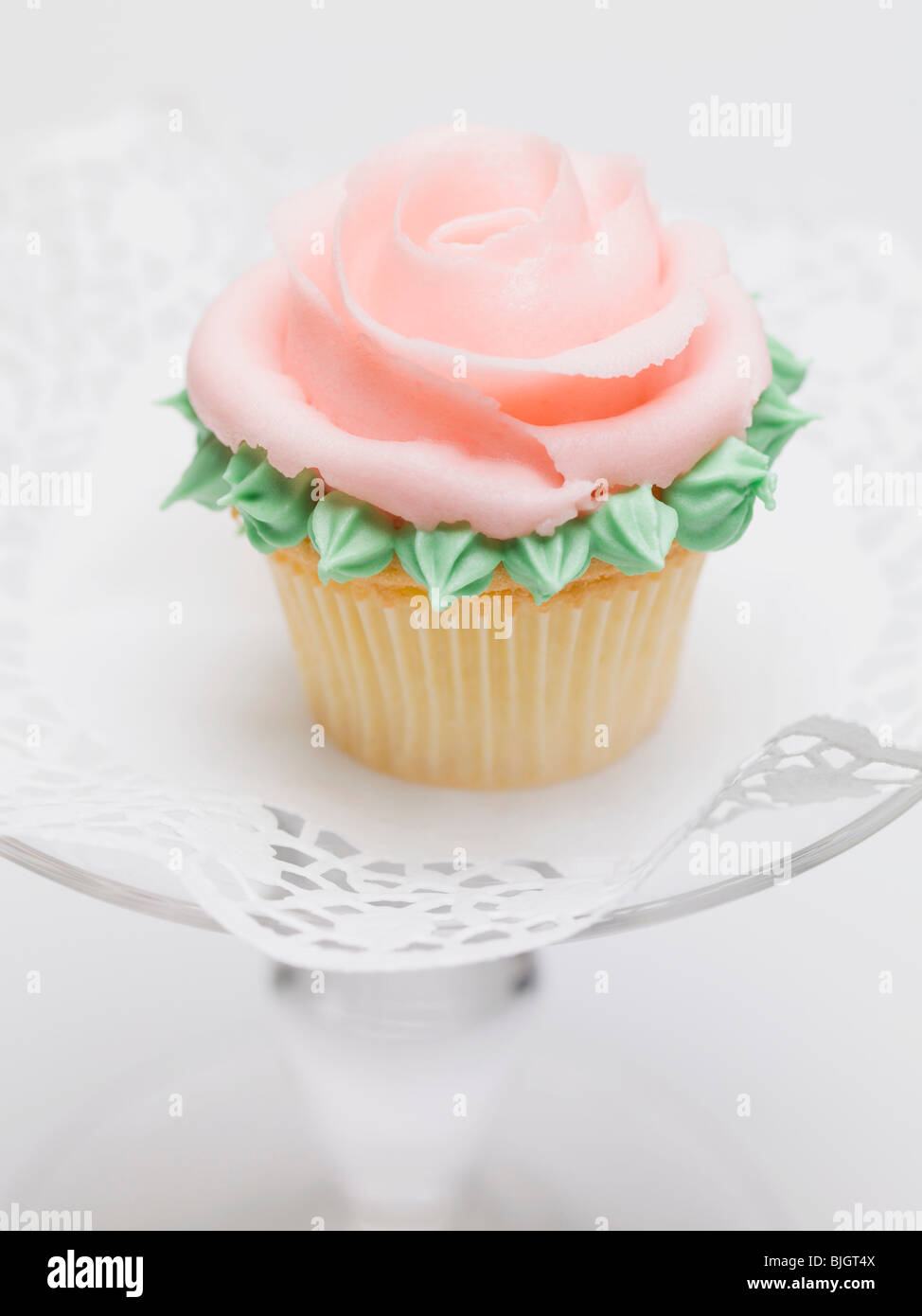 Rose muffin on glass cake stand Stock Photo - Alamy