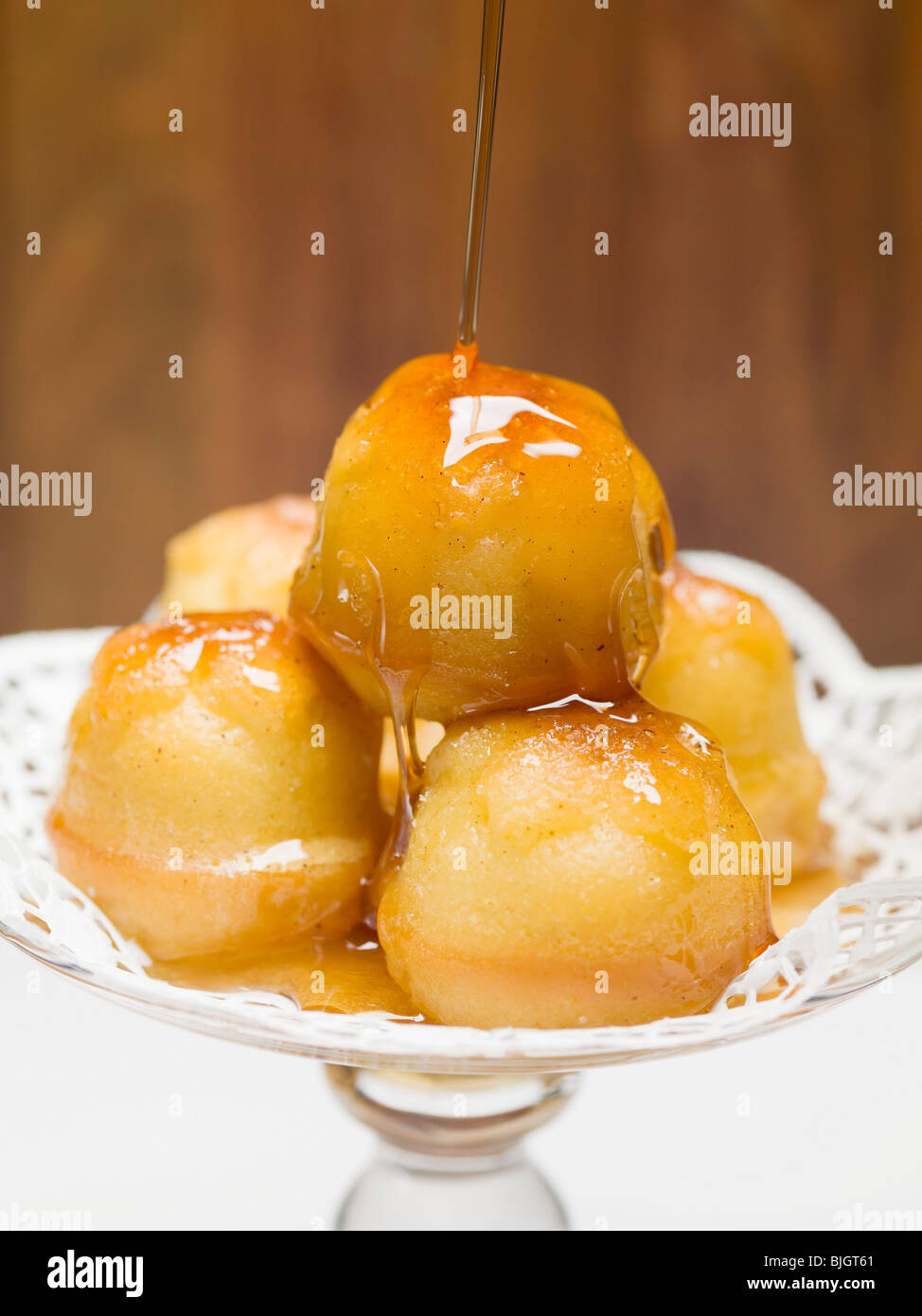 Soaking babas in maple syrup Stock Photo - Alamy