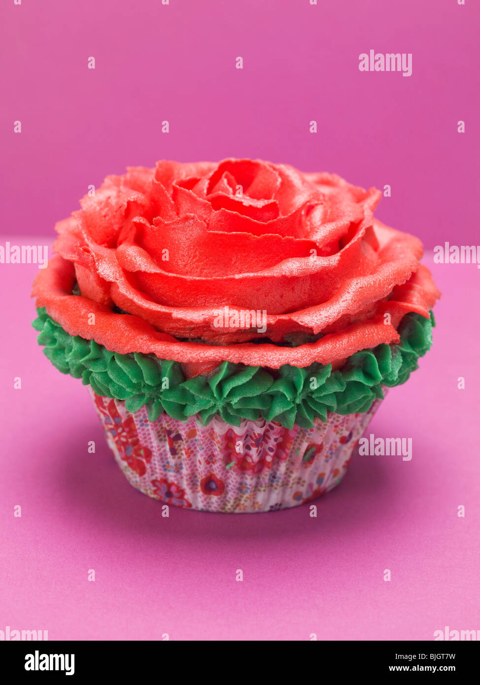 Cupcake with red marzipan rose Stock Photo - Alamy