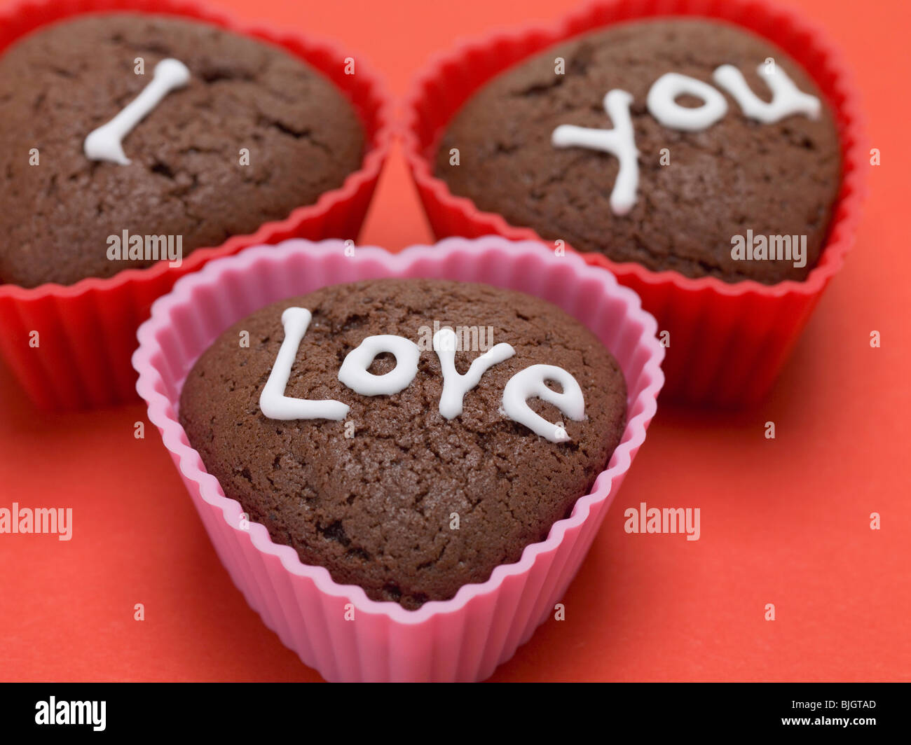 Heart-shaped chocolate muffins with sugar writing Stock Photo - Alamy