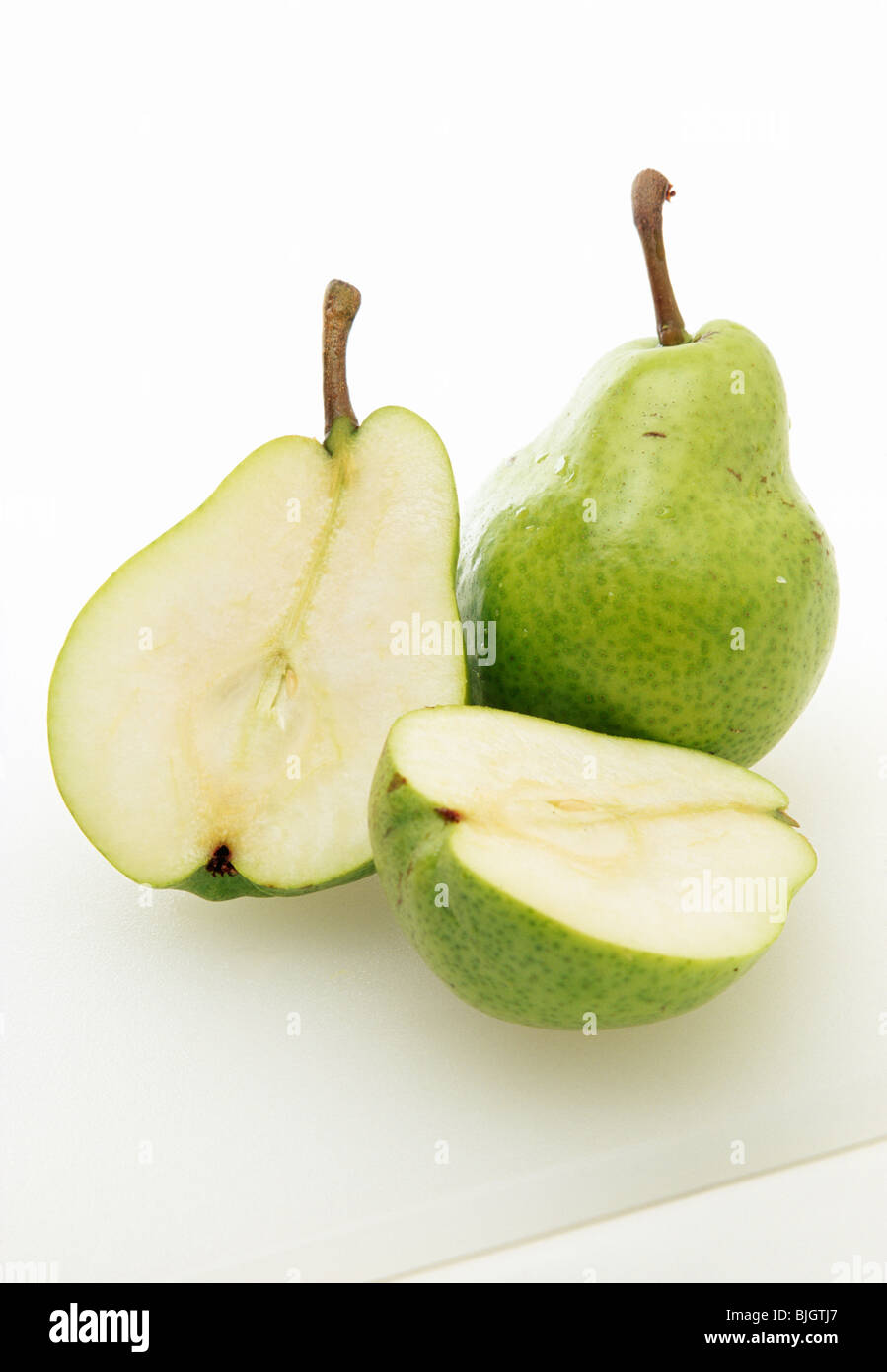 Whole green pear half Cut Out Stock Images & Pictures - Alamy