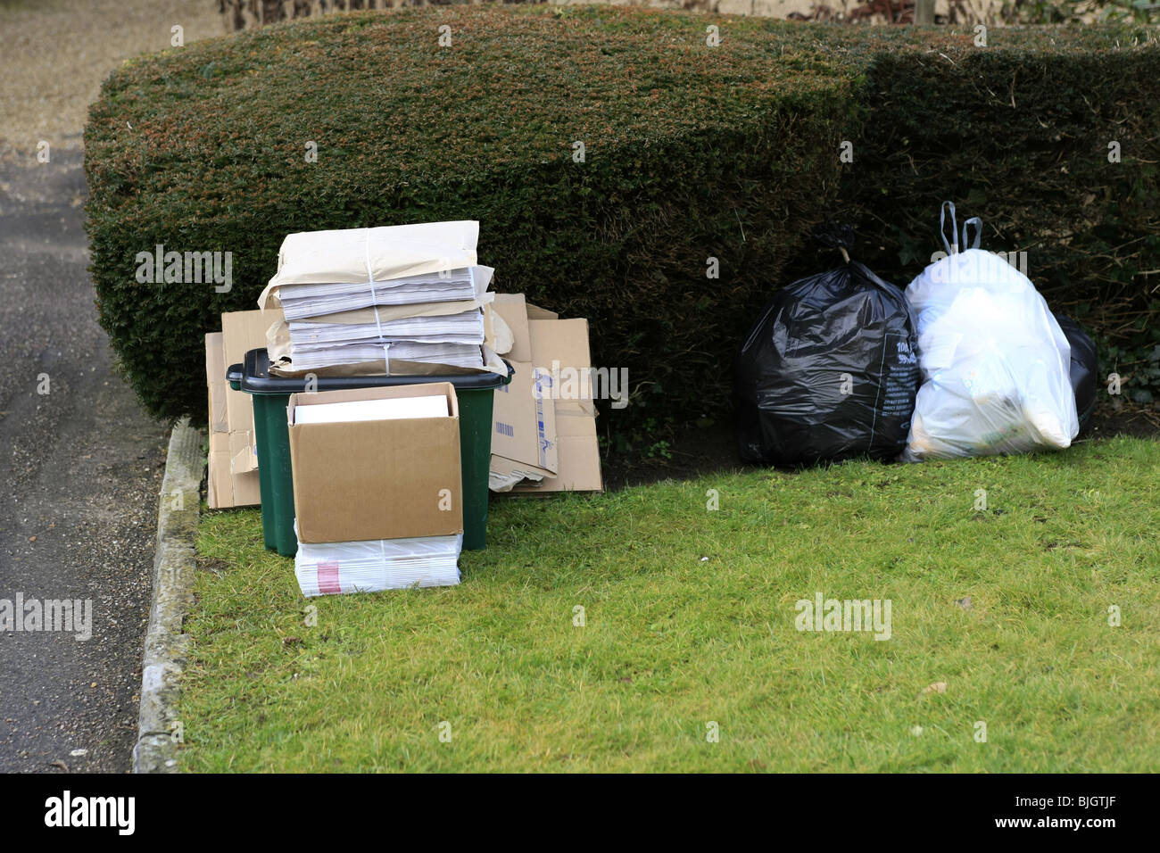 Cardboard and paper waste ready for recycling collection by the loacl ...