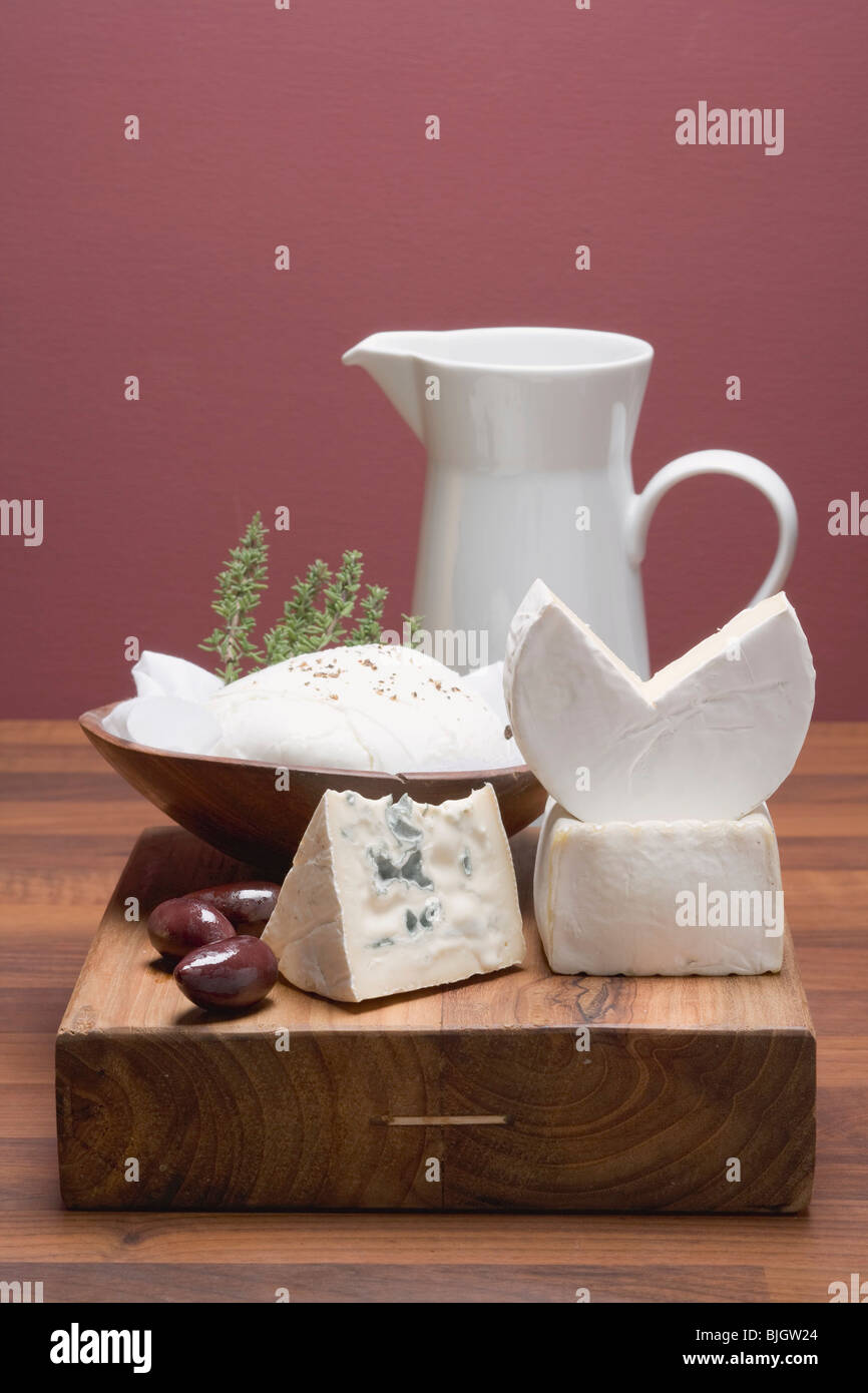 Cheese still life with olives and thyme Stock Photo - Alamy