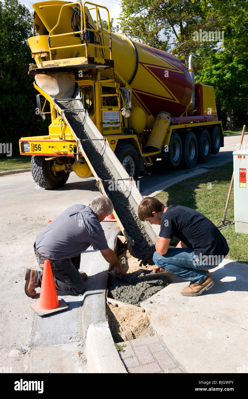 Cement workers work to repair roadway Stock Photo - Alamy