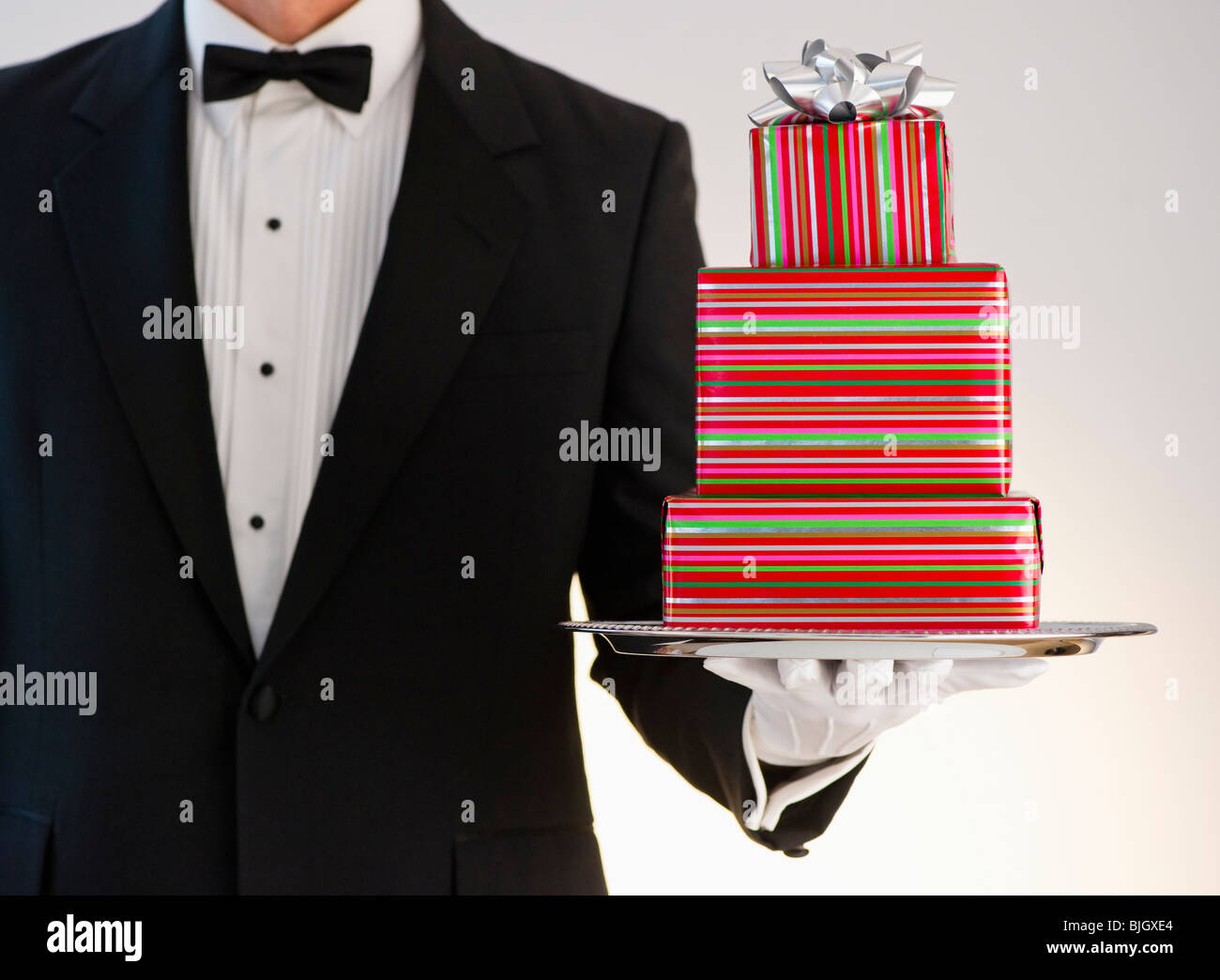 Butler holding gifts Stock Photo - Alamy