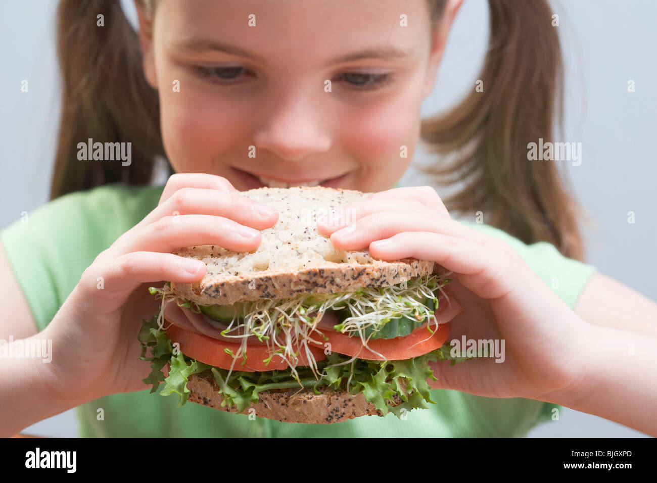 Girl with large sandwich Stock Photo - Alamy