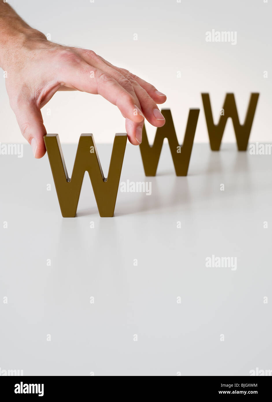 Hand touching letter W Stock Photo - Alamy