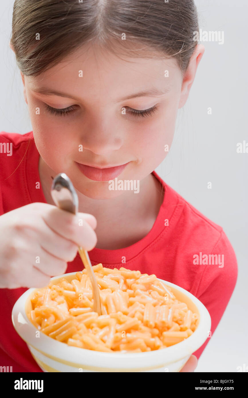Little girl eating pasta Stock Photo - Alamy
