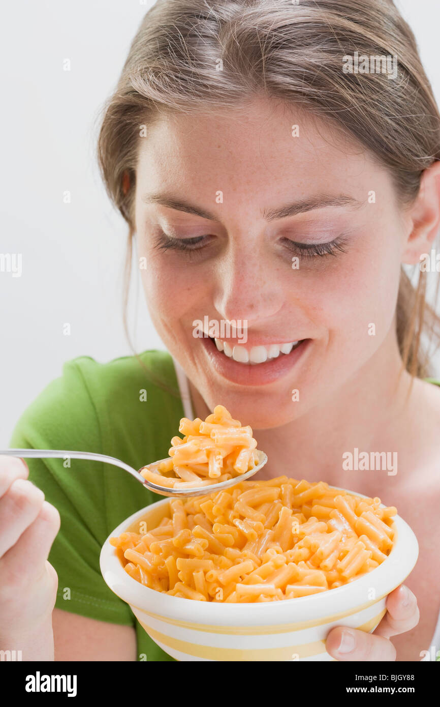 Young woman with pasta on spoon Stock Photo - Alamy