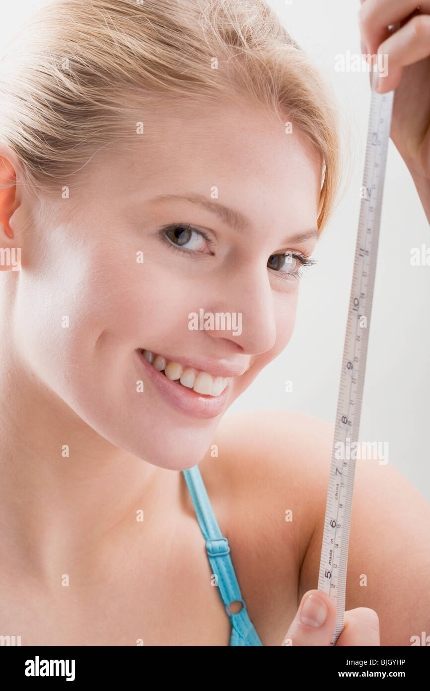 Woman with tape measure Stock Photo - Alamy