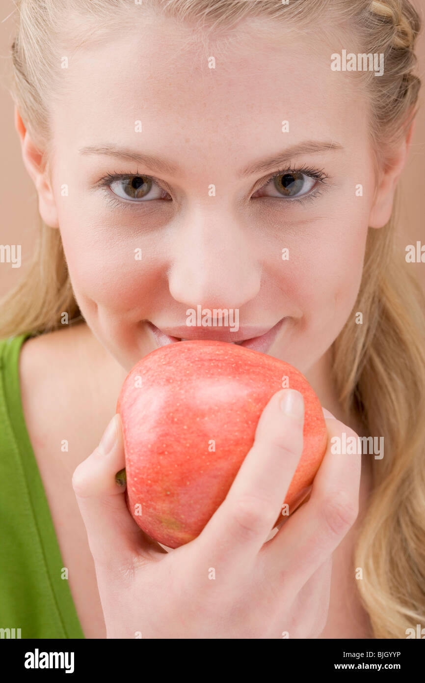 Woman eating red apple Stock Photo - Alamy
