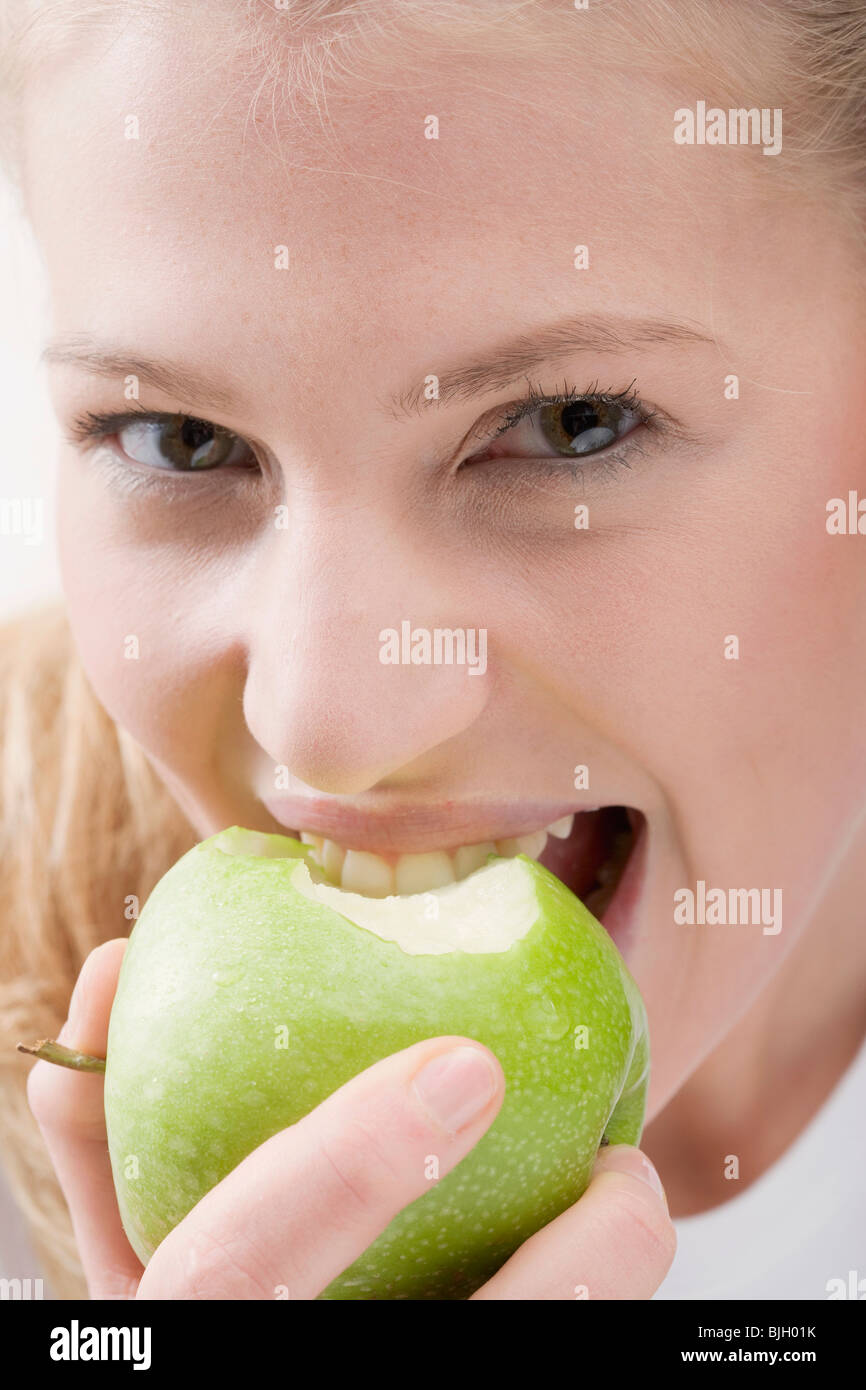 Woman eating green apple Stock Photo - Alamy
