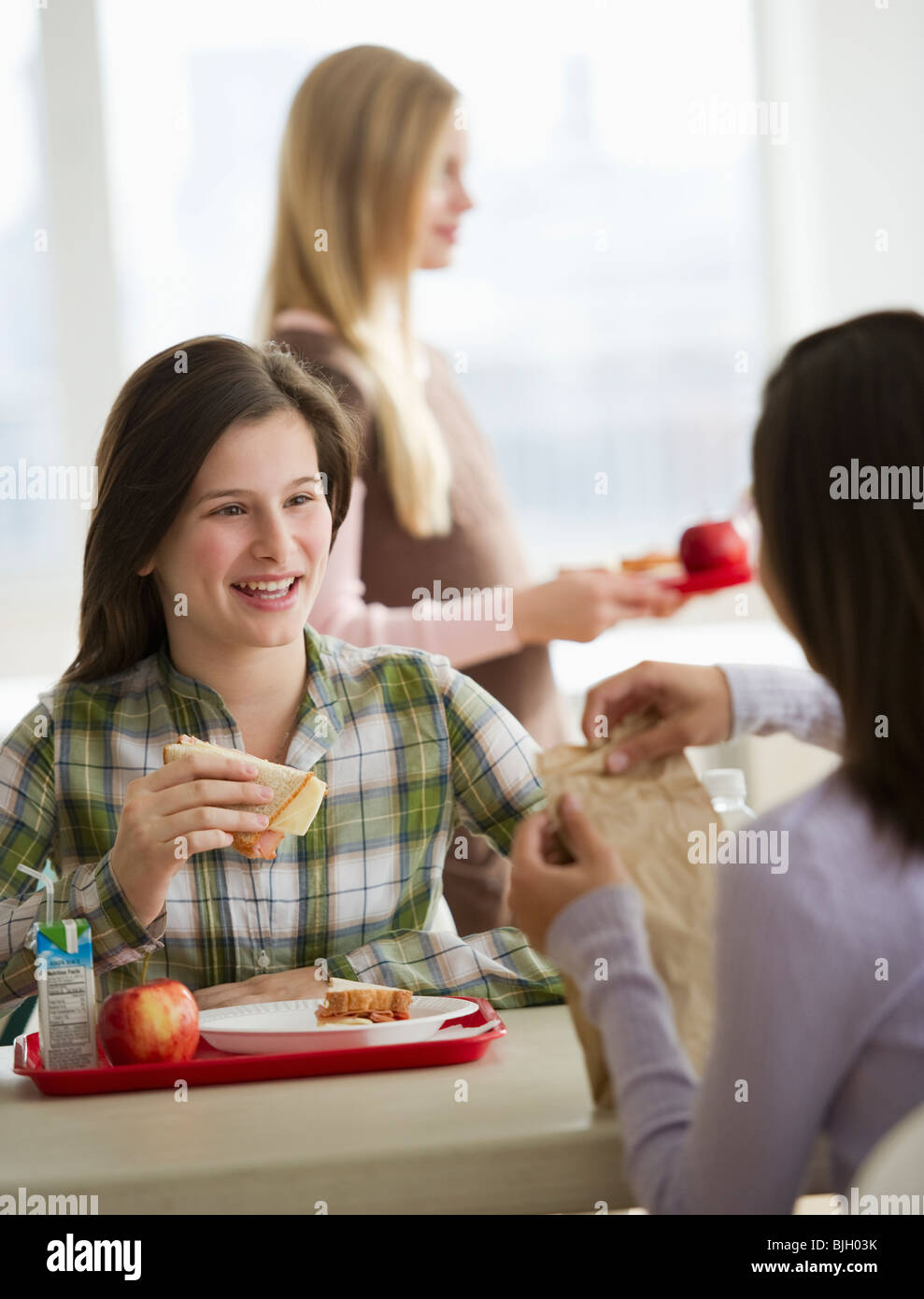 Friends eating in cafeteria Stock Photo - Alamy