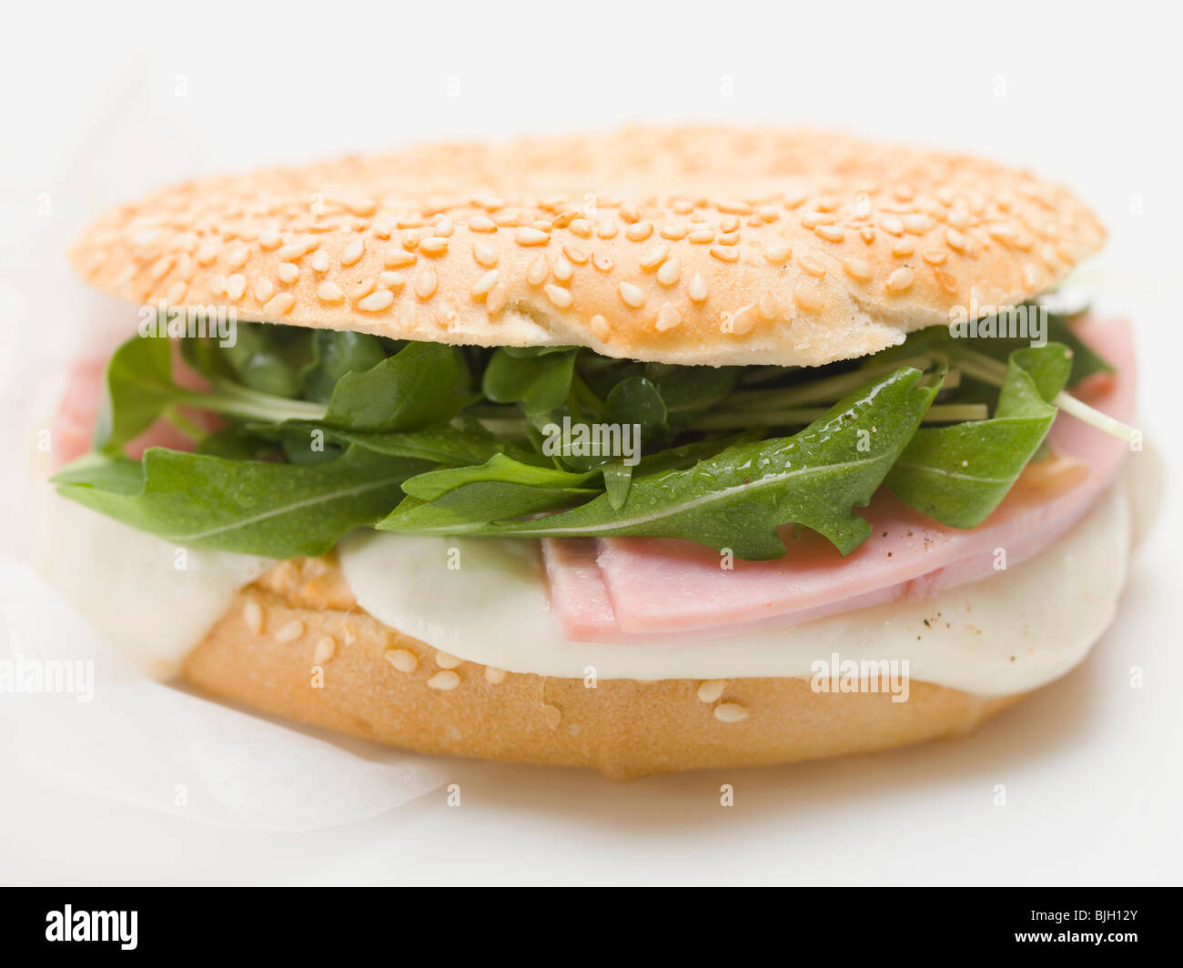 Ham, cheese and rocket in sesame bagel Stock Photo - Alamy
