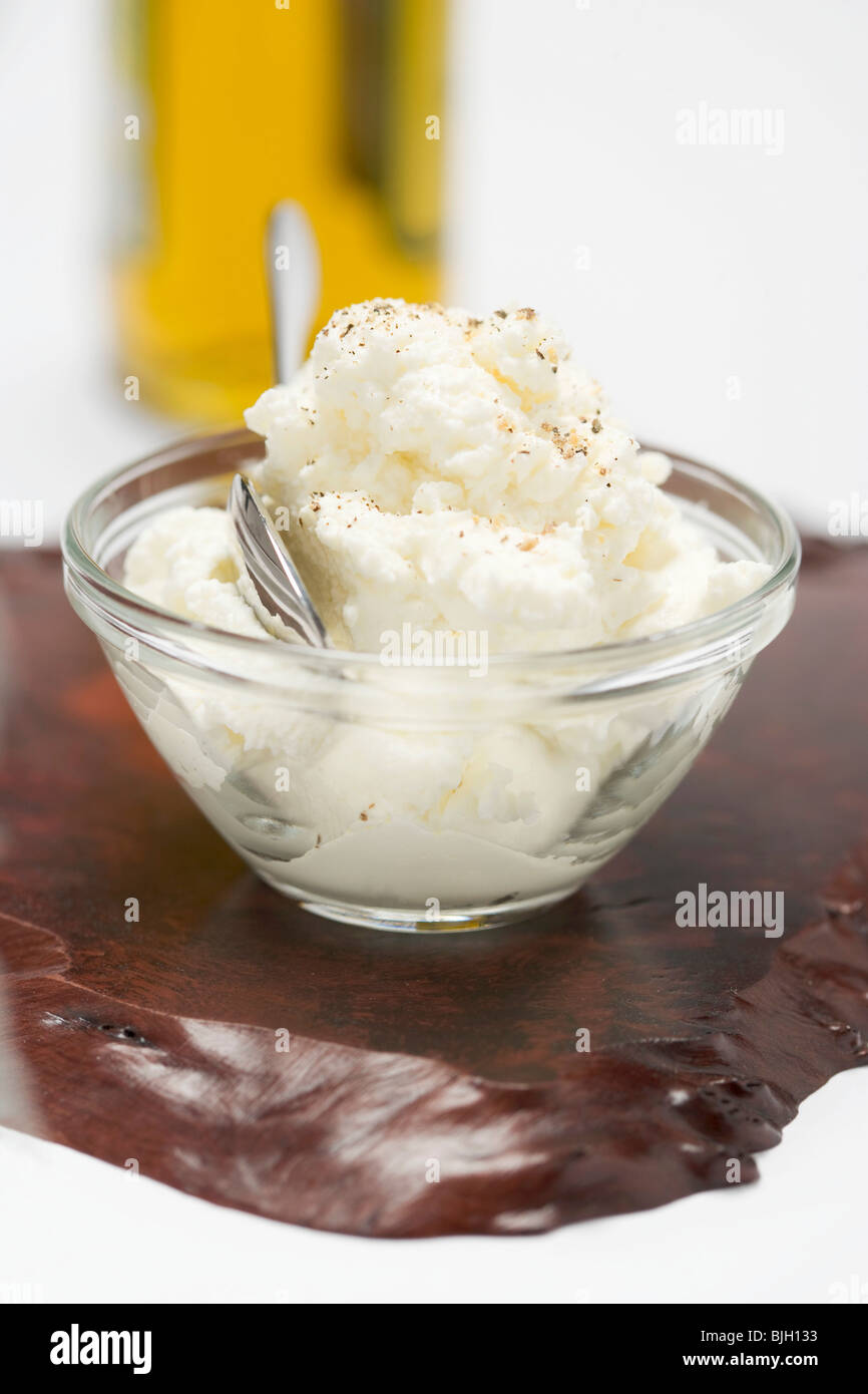 Quark in glass dish with spoon Stock Photo - Alamy