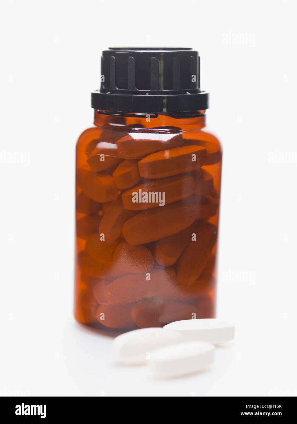 Tablets in and beside bottle Stock Photo - Alamy