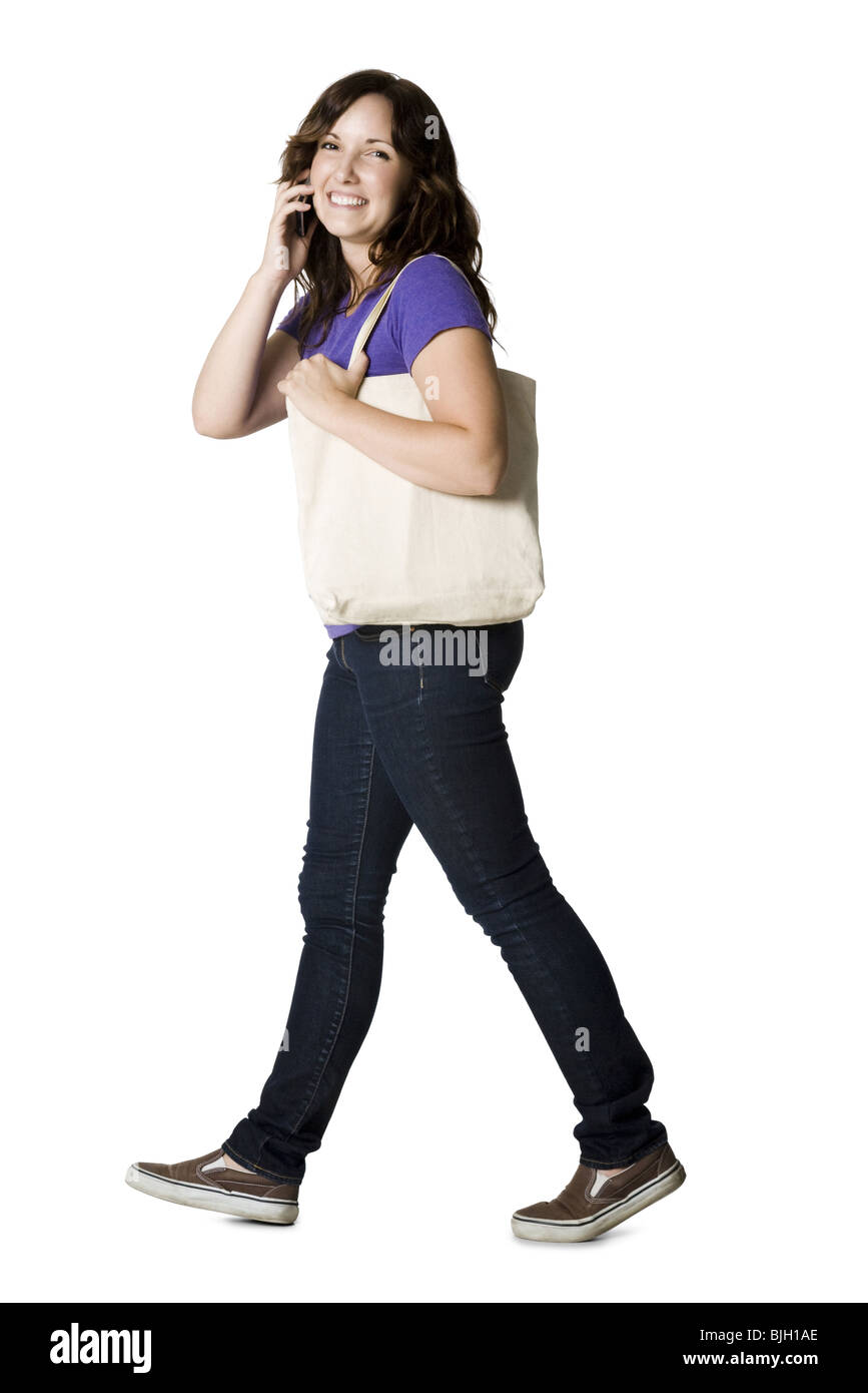 woman walking with a cell phone Stock Photo - Alamy