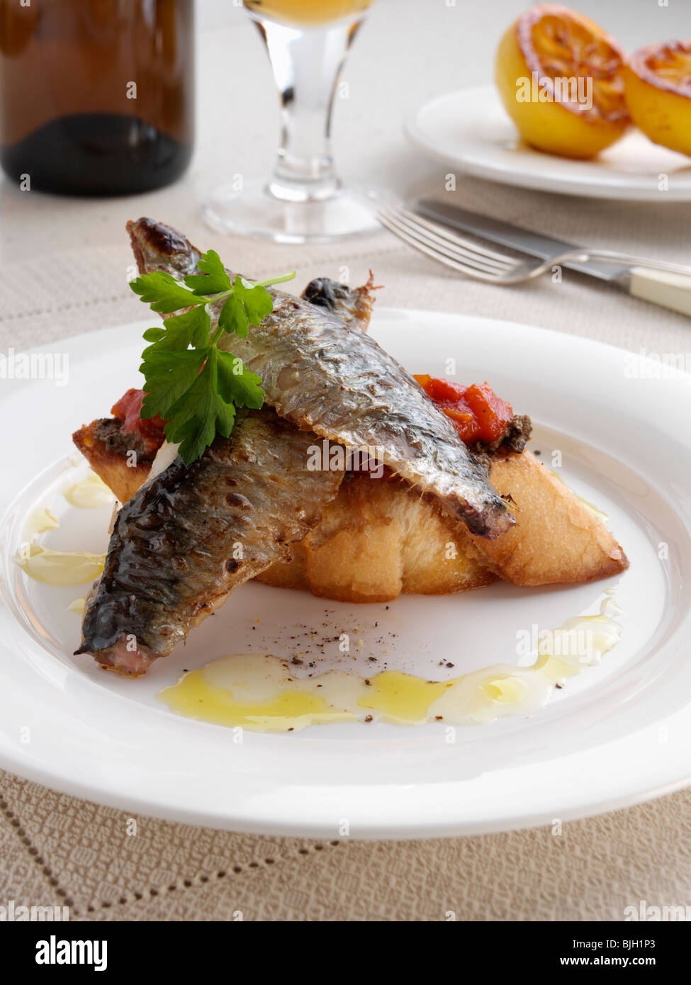 Sardine fillets on toast with a tapenade and tomato compote Stock Photo ...