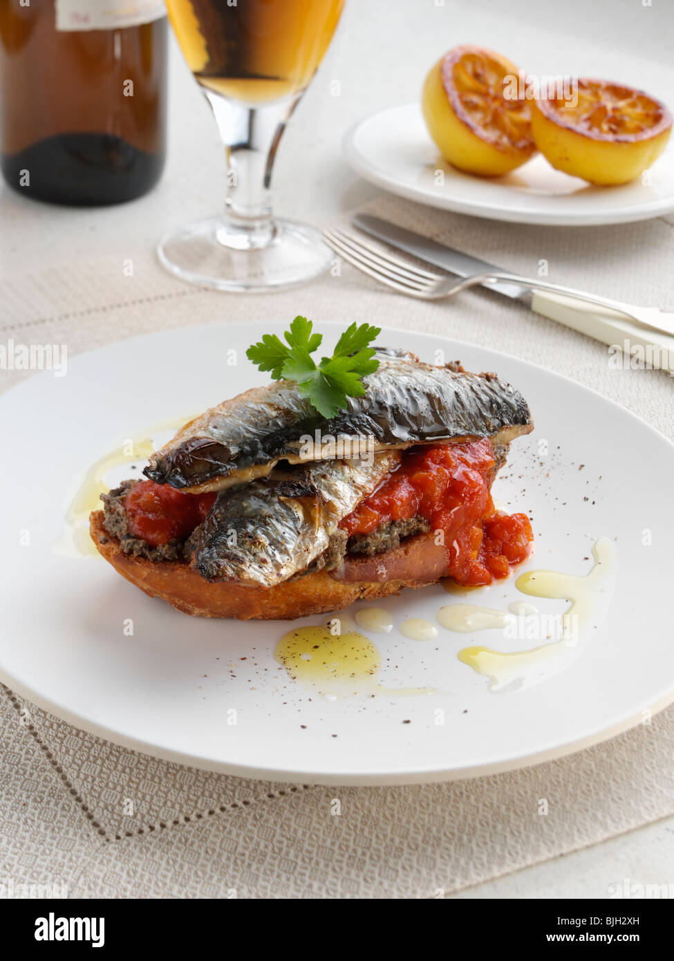 Sardine fillets on toast with a tapenade and tomato compote Stock Photo ...