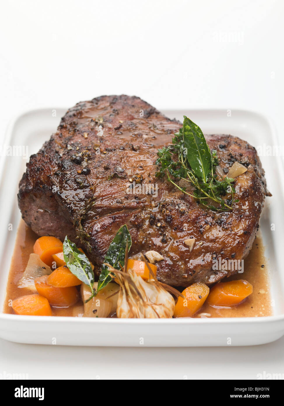 Boned leg of wild boar with carrots Stock Photo - Alamy