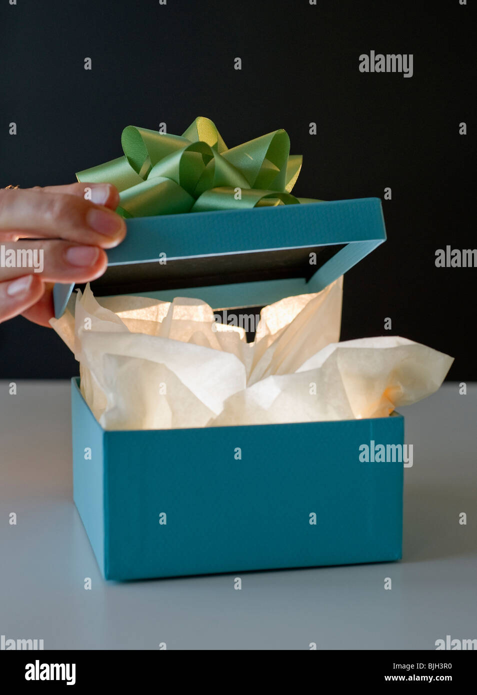 Opening a gift Stock Photo - Alamy