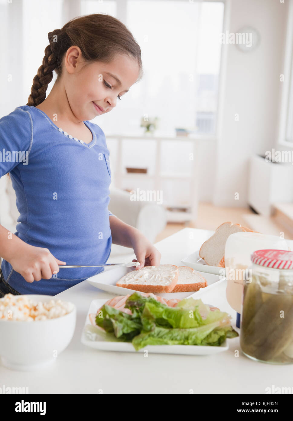 Young girl making sandwich Stock Photo - Alamy