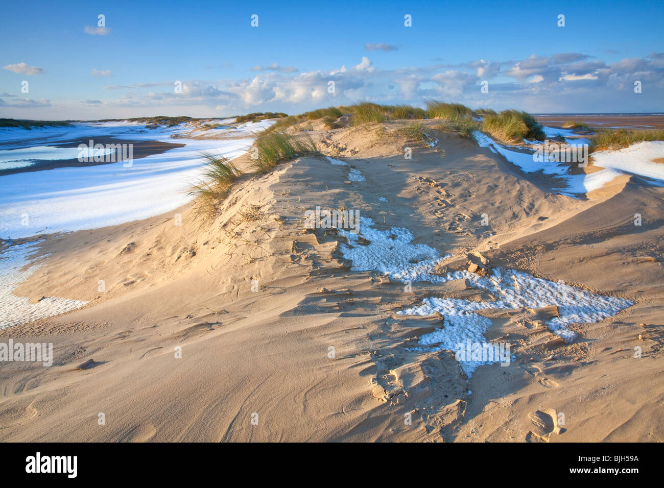 Winter snow on the beach and sand dunes at Holkham Bay on the North ...
