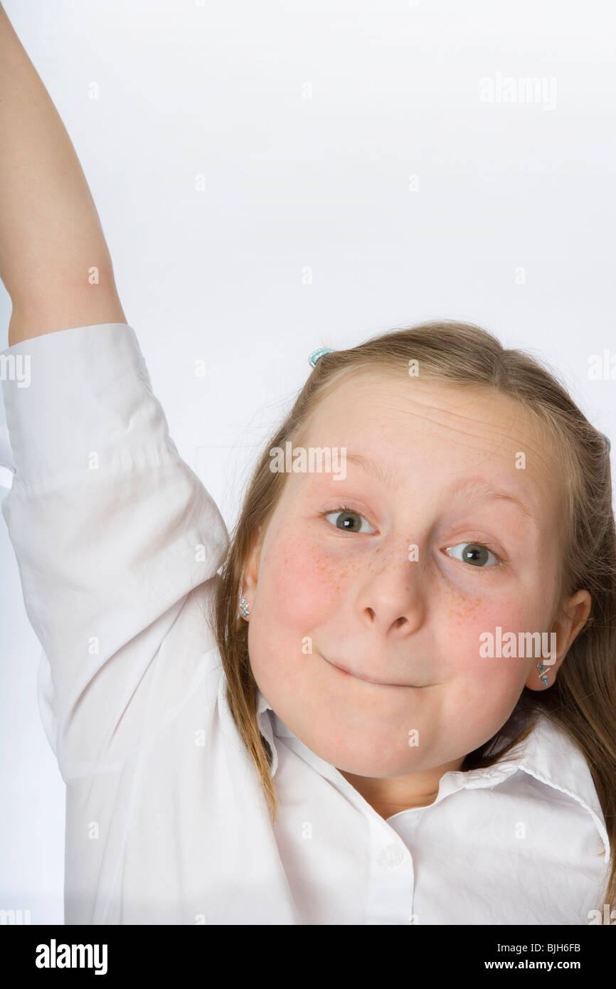 A school girl putting her hand up to answer a question Stock Photo - Alamy