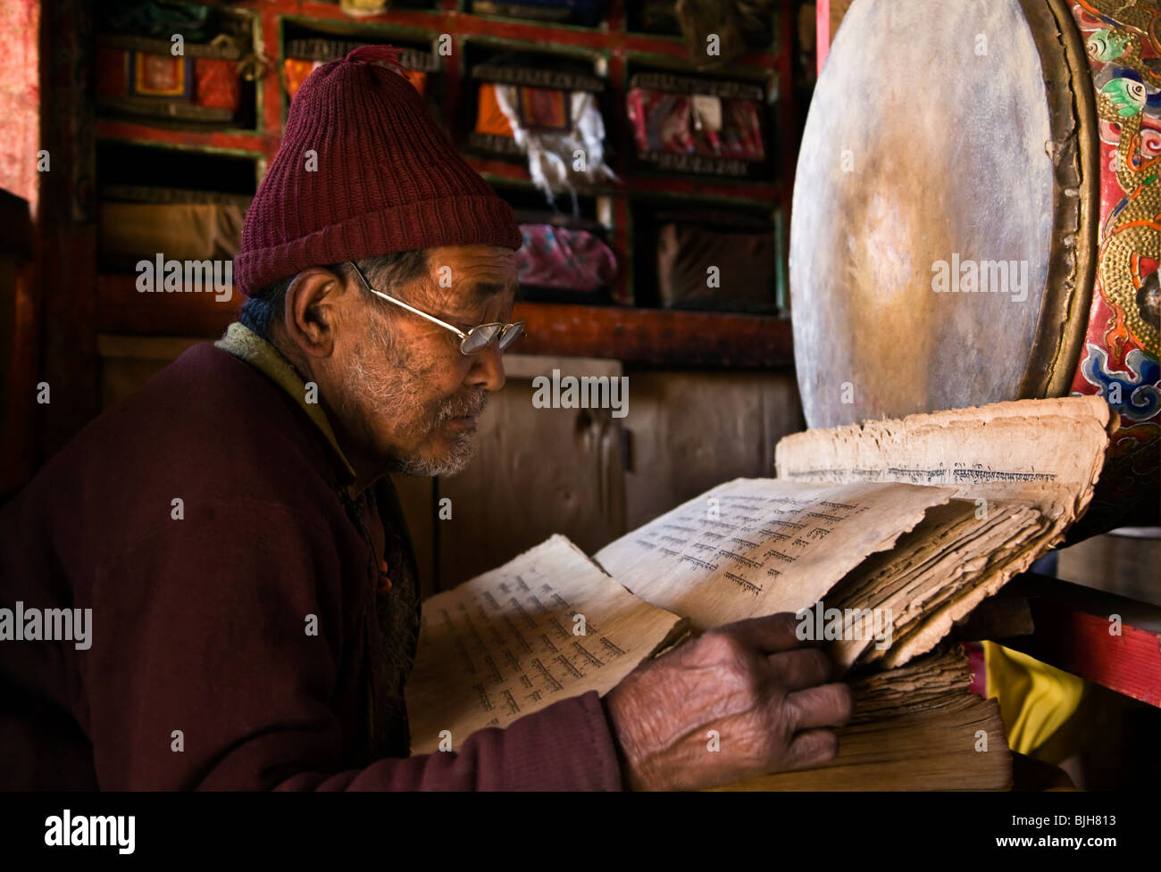 A TIBETAN BUDDHIST MONK reads SACRED TEXTS in the village of SAMDO on ...